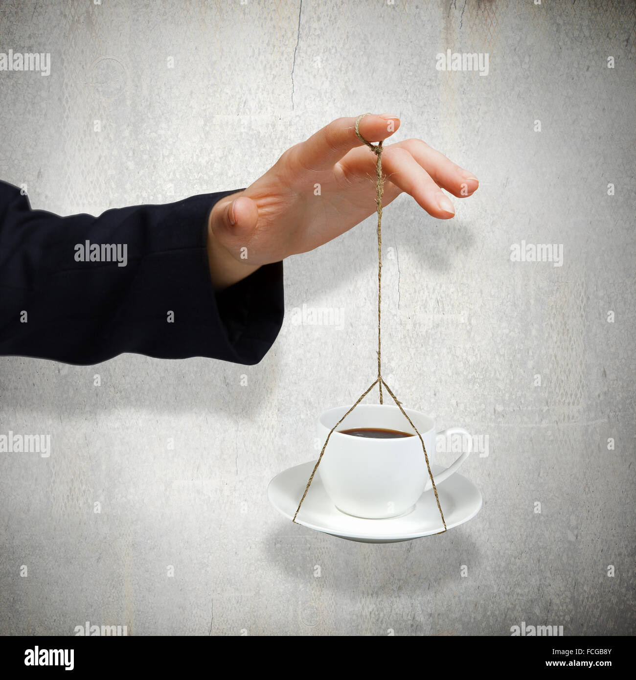 Close up of male hand holding coffee cup on finger Stock Photo - Alamy