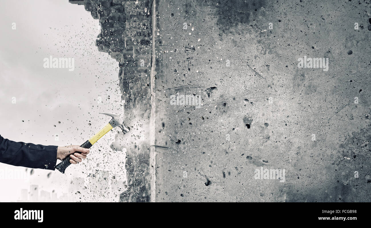 Close up of female hand crashing wall with hammer Stock Photo - Alamy
