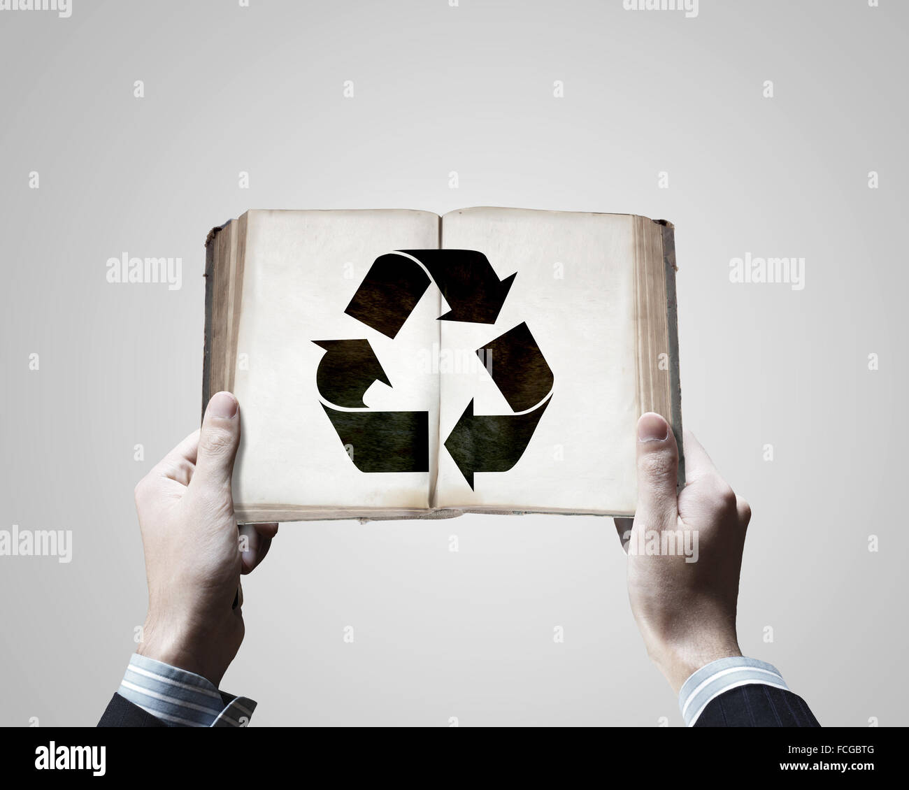 Close up f male hands holding opened book with recycle sign Stock Photo ...