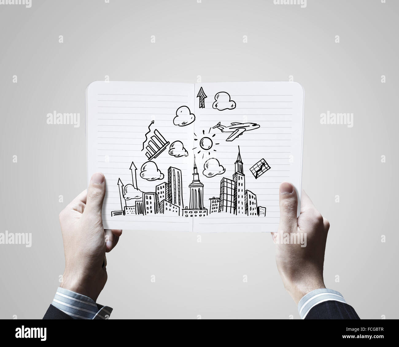 Close up of businessman hands holding opened notepad with sketches ...