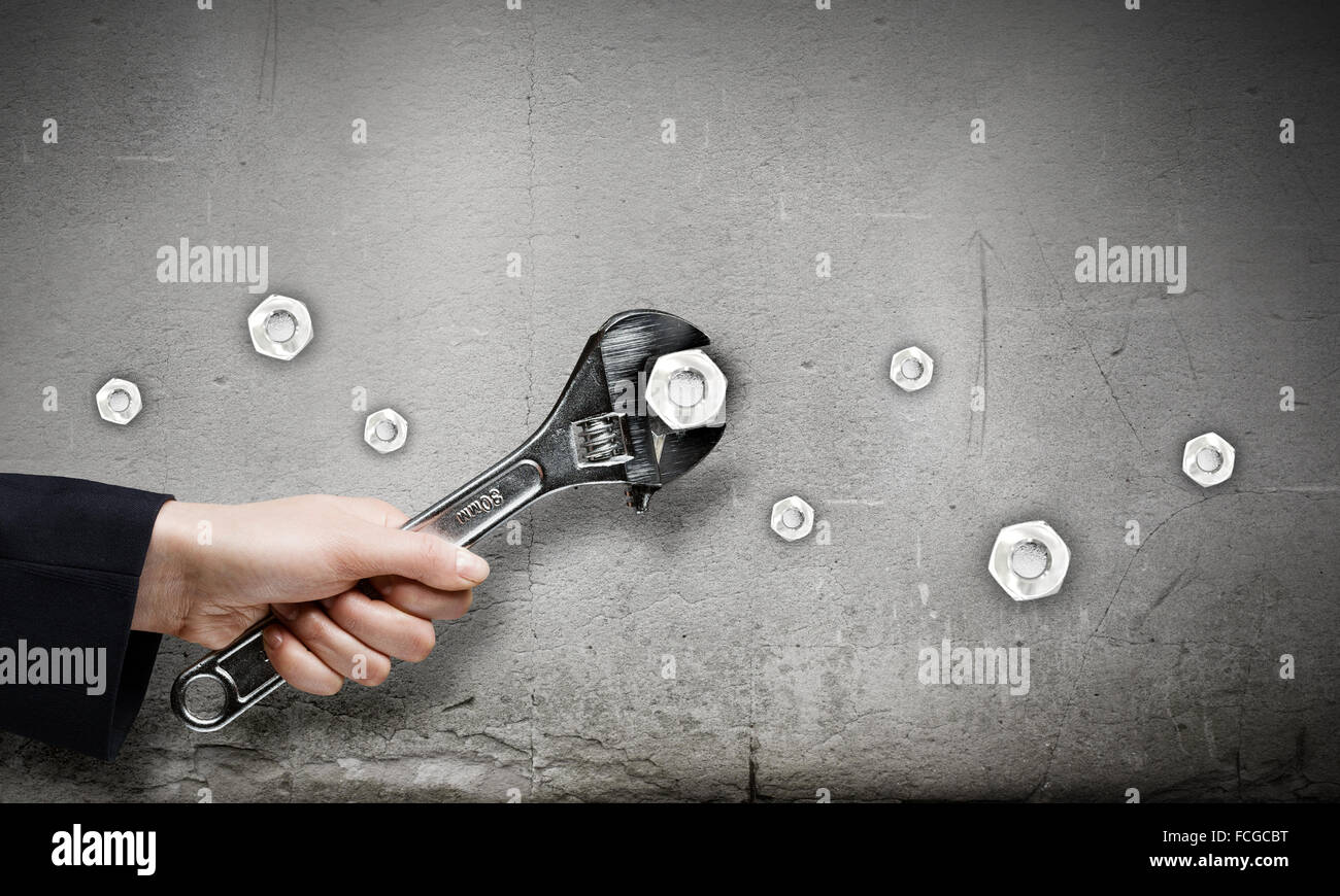 Close up of businessman hand fixing mechanism with spanner Stock Photo ...