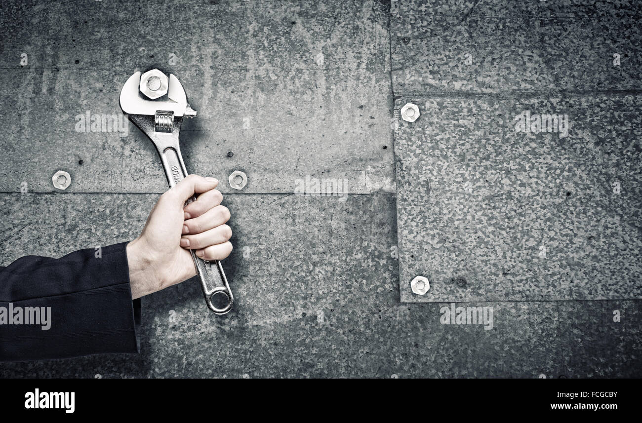 Close up of businessman hand fixing mechanism with spanner Stock Photo ...