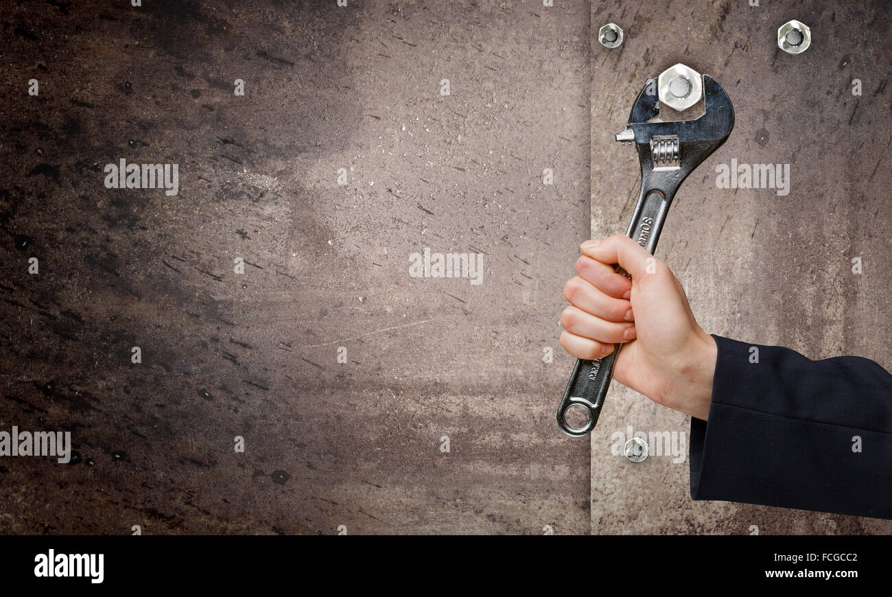 Close up of businessman hand fixing mechanism with spanner Stock Photo ...