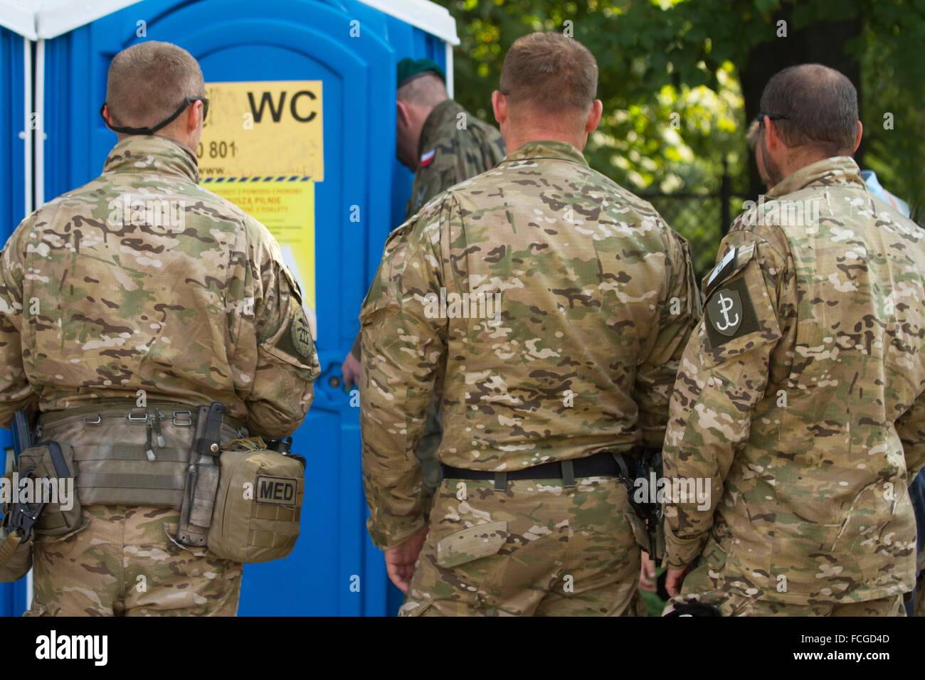 Soldiers waiting before a WC. Poland Stock Photo - Alamy