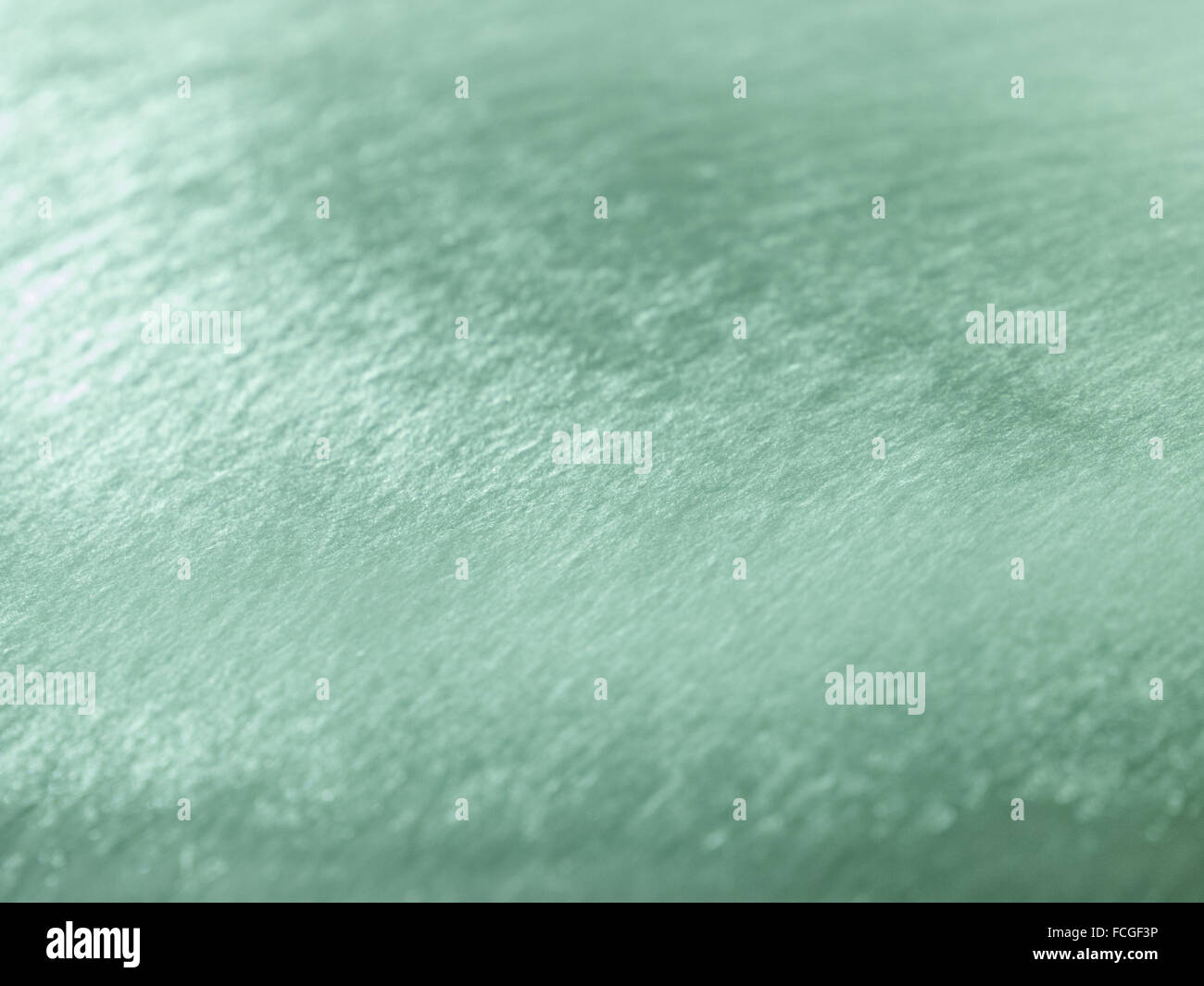 Wet green windshield at the car wash with streaks of water and blurry ...