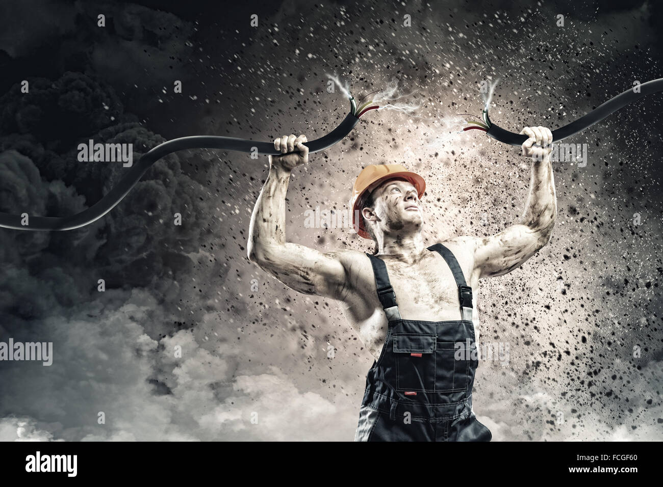 Strong man in uniform tearing electricity cable with hands Stock Photo ...