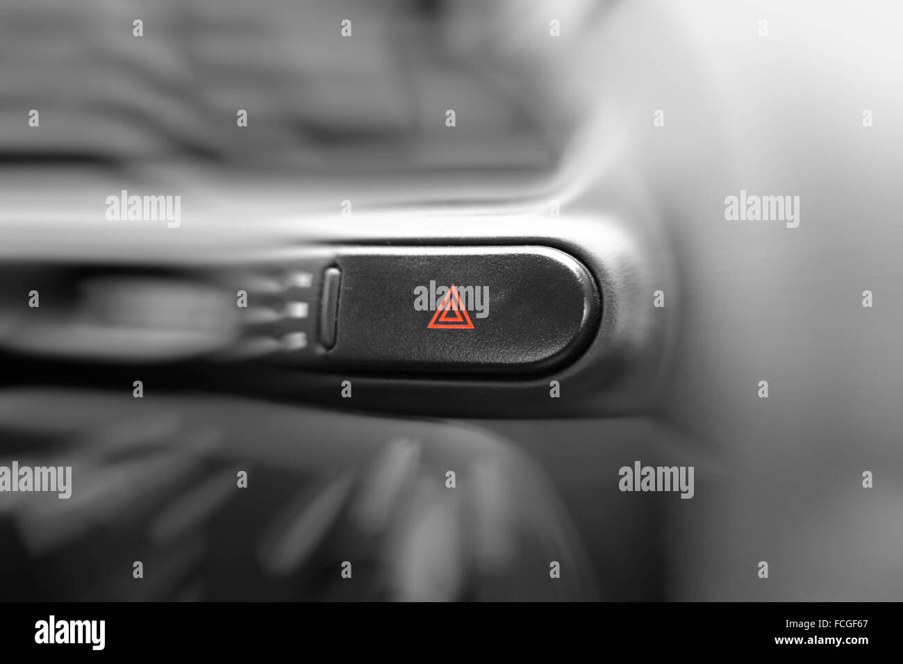 Car emergency lights button on cockpit. Very shallow DOF, focus on ...