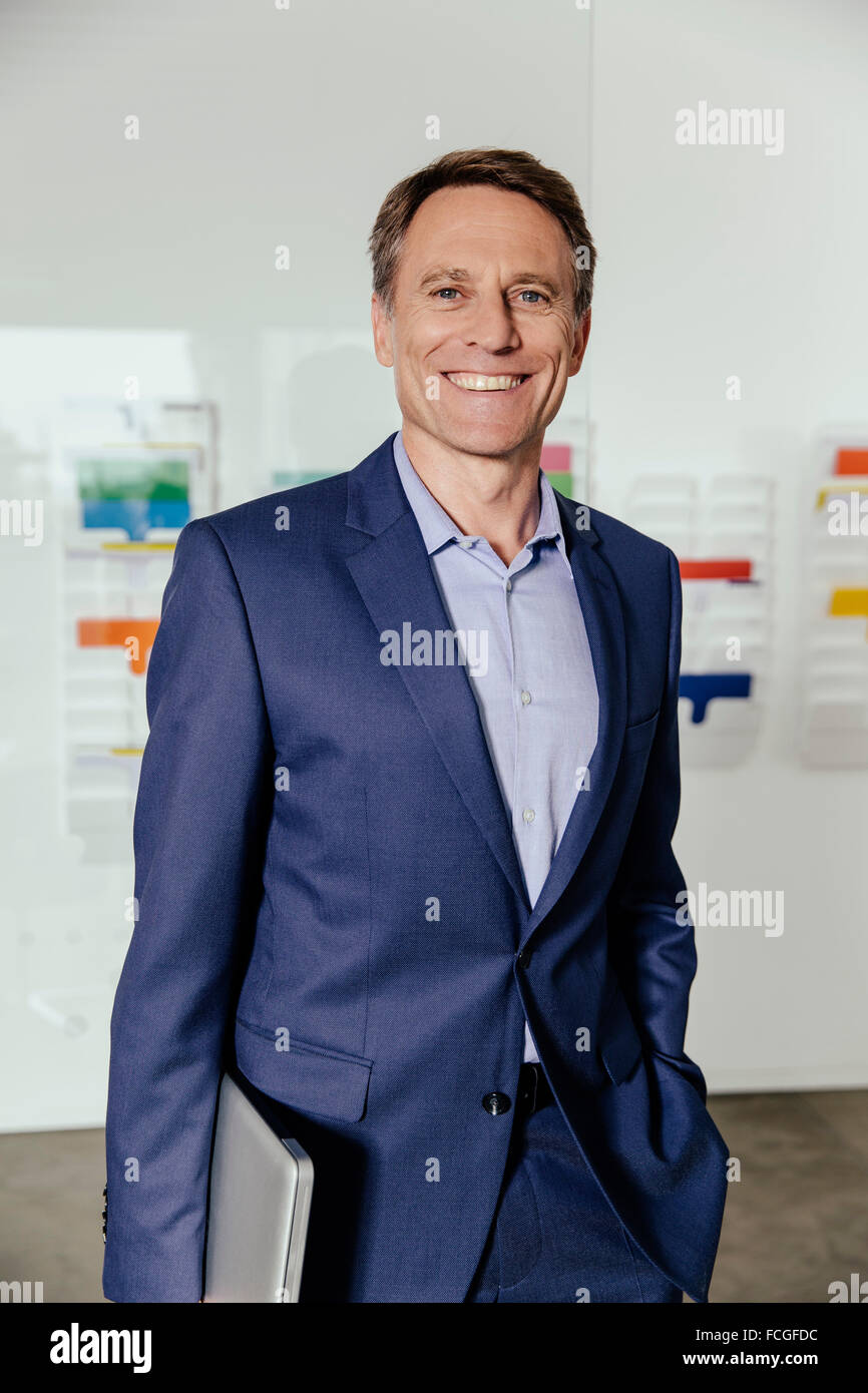 Male manager standing in office Stock Photo - Alamy