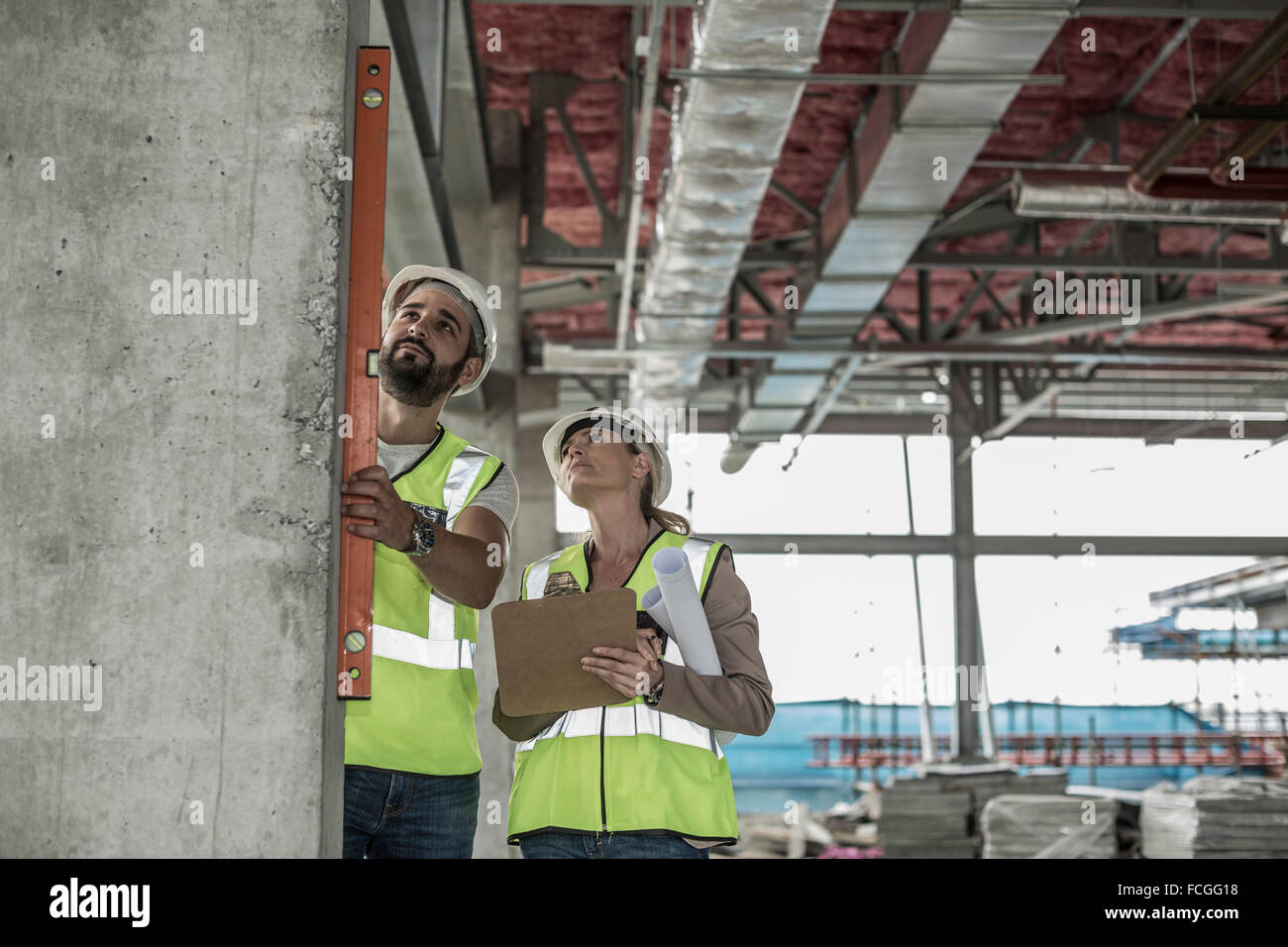 Woman construction worker using water level in construction site Stock ...