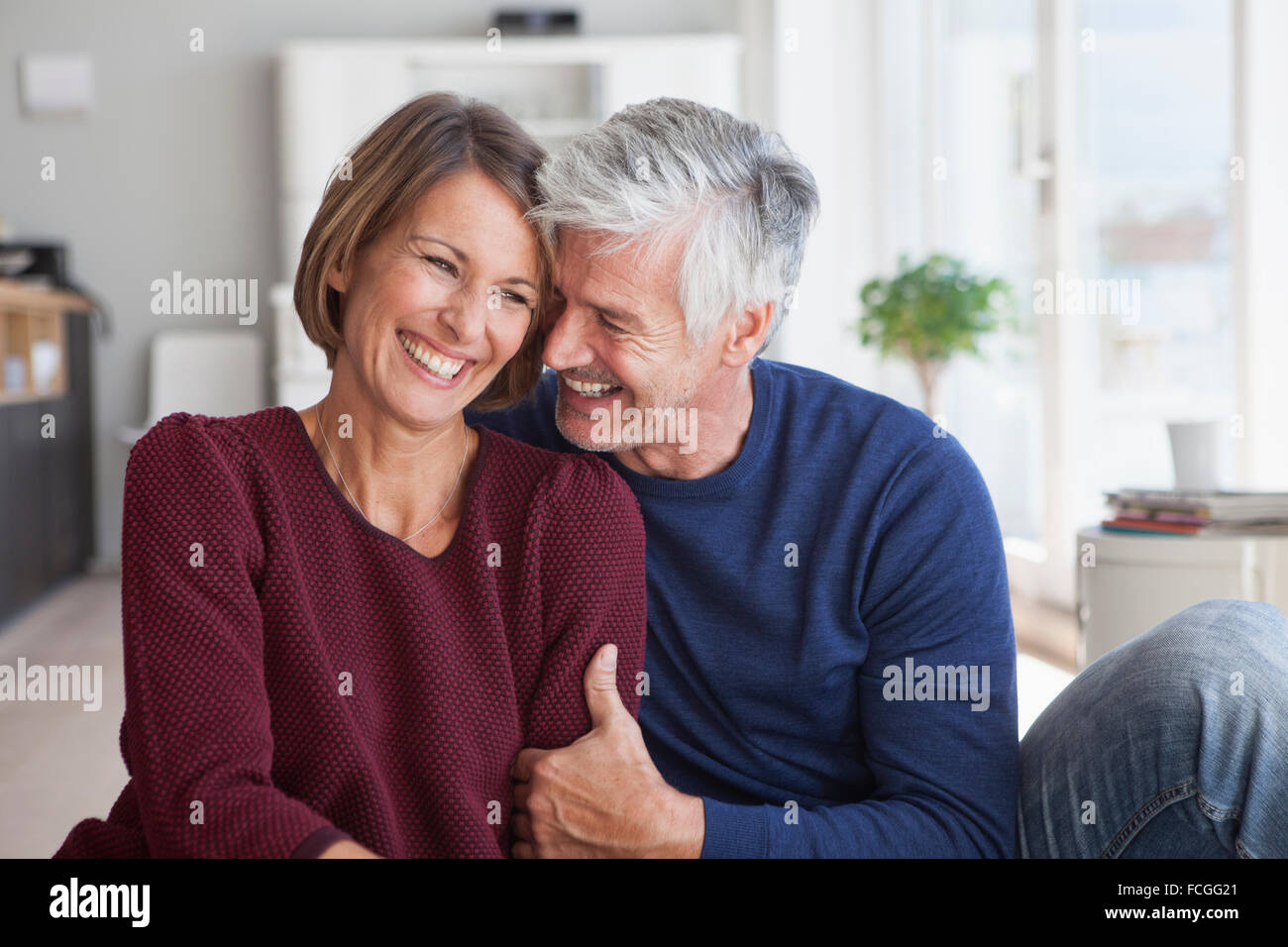 Laughing couple at home Stock Photo - Alamy