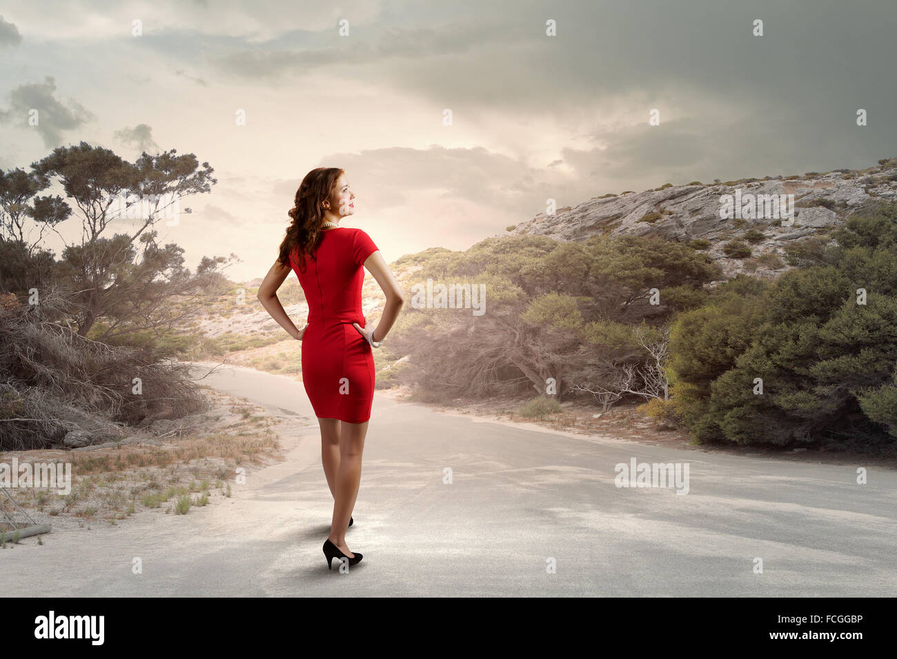 Rear view of young woman standing aside of road Stock Photo - Alamy
