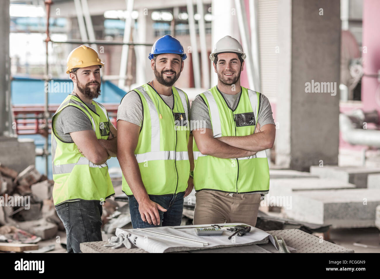 Portrait of confident construction workers in construction site Stock ...
