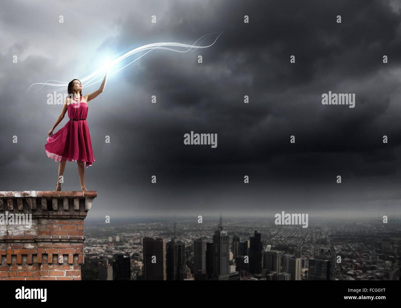 Young woman in red dress standing on top of building Stock Photo - Alamy