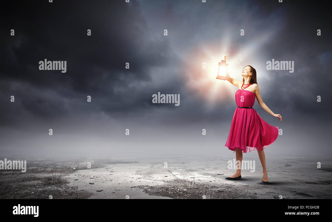 Young woman in red dress with lantern Stock Photo - Alamy