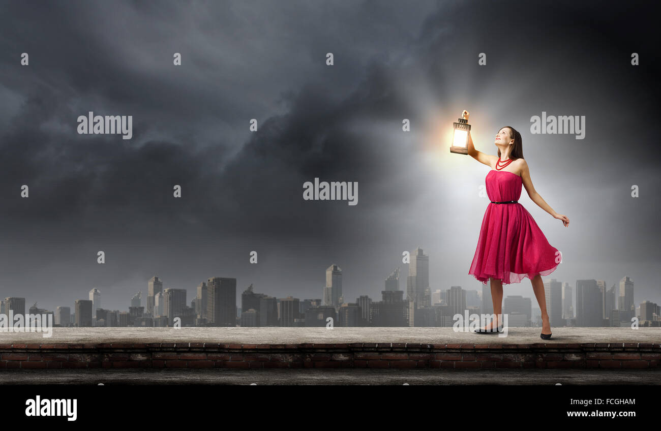 Young woman in red dress with lantern Stock Photo - Alamy