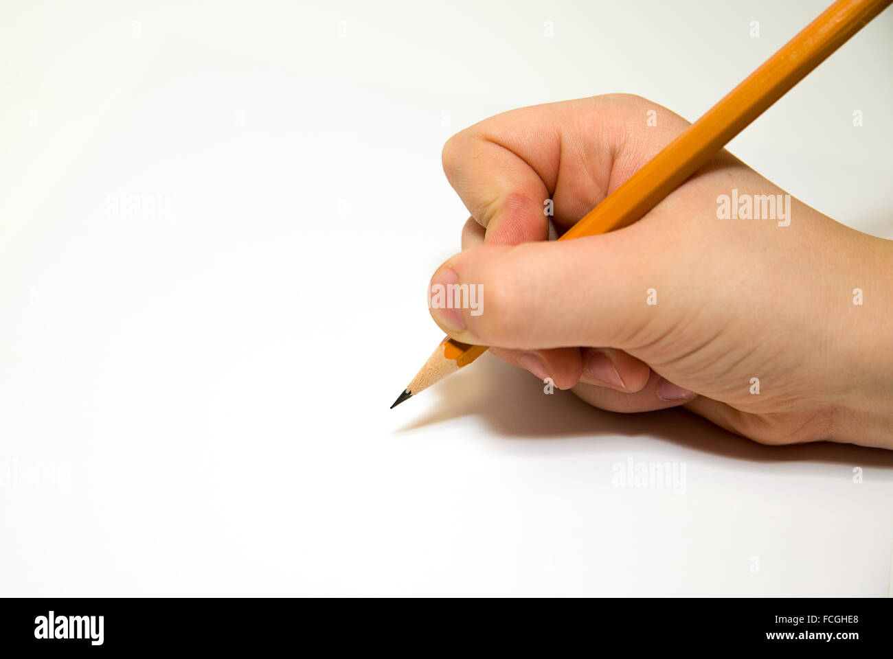 Kid's rigth hand holding a pencil on a white Stock Photo - Alamy
