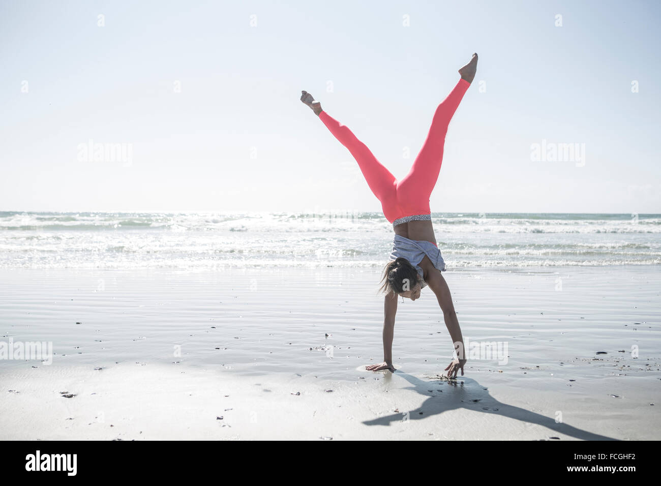 Woman doing handstand beach hi-res stock photography and images - Alamy
