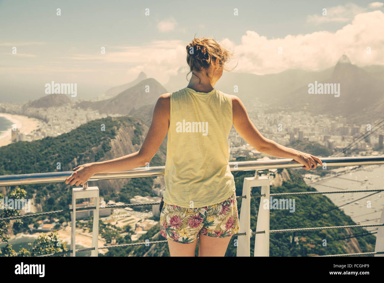 Brazil Woman looking down onto Rio de Janeiro from Sugarloaf Mountain ...