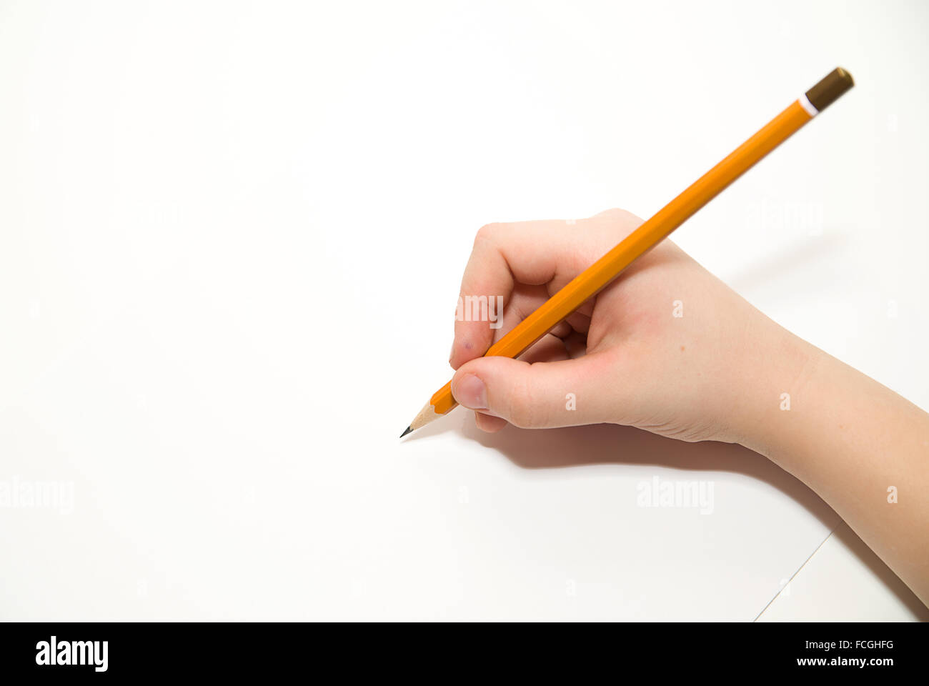 Kid's rigth hand holding a pencil on a white Stock Photo - Alamy
