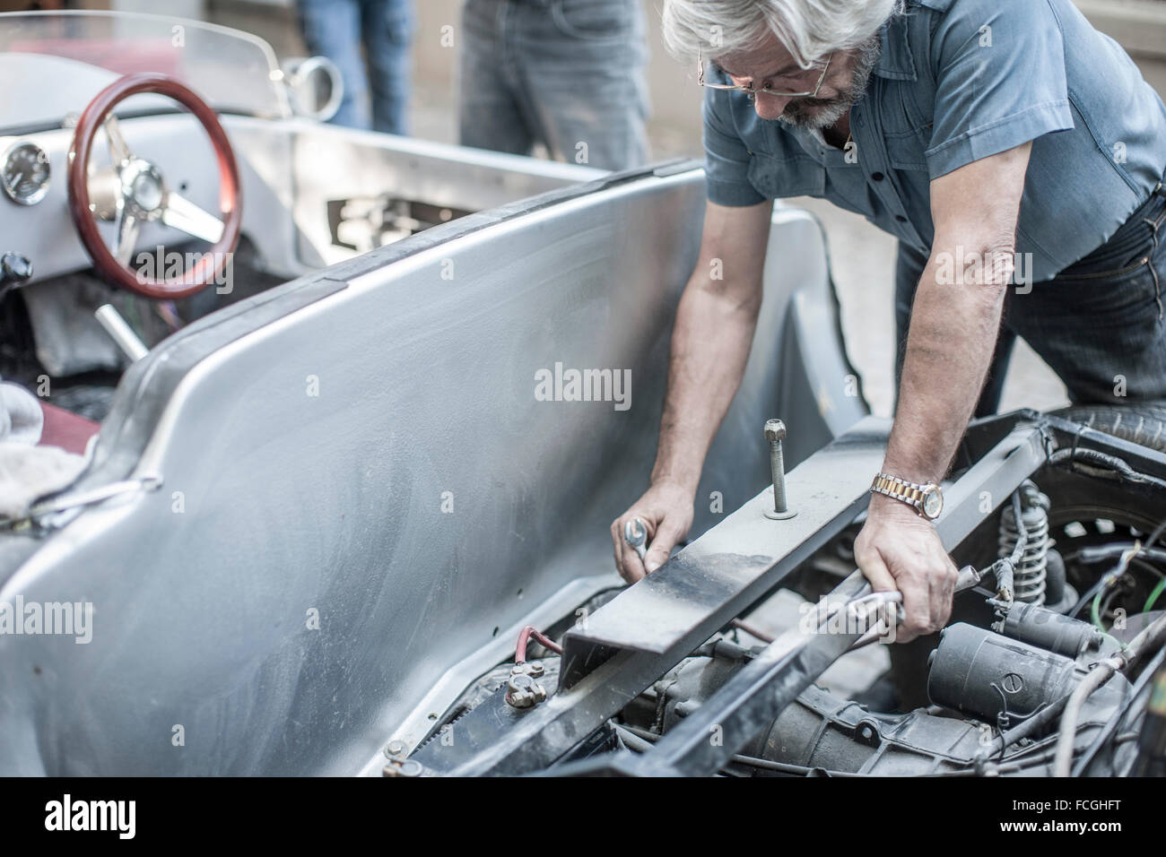 Senior man restoring a car Stock Photo - Alamy