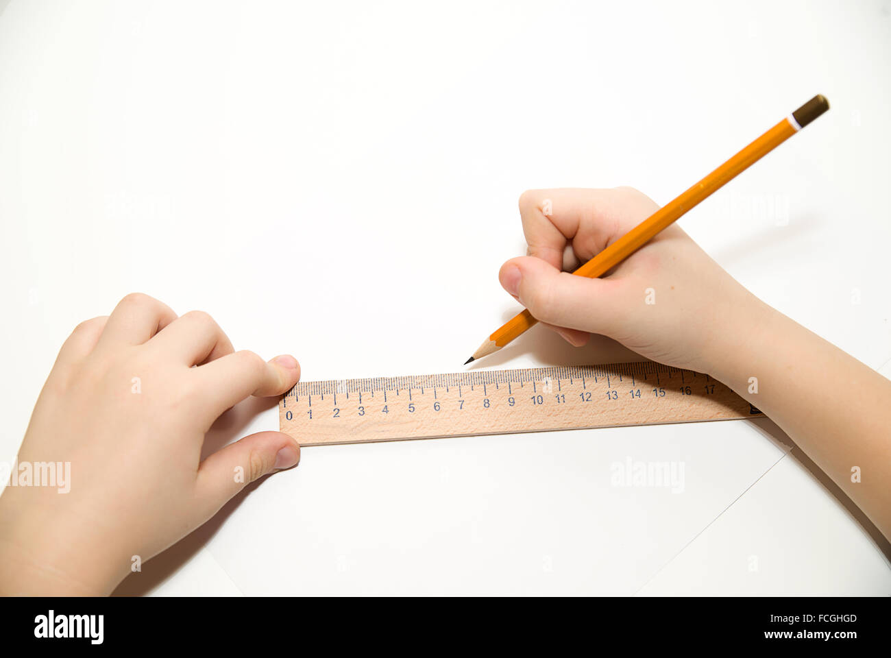 Kid's hands holding a pencil on a white Stock Photo - Alamy