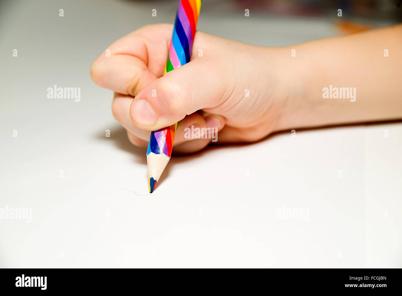 Kid's rigth hand holding a pencil on a white Stock Photo - Alamy