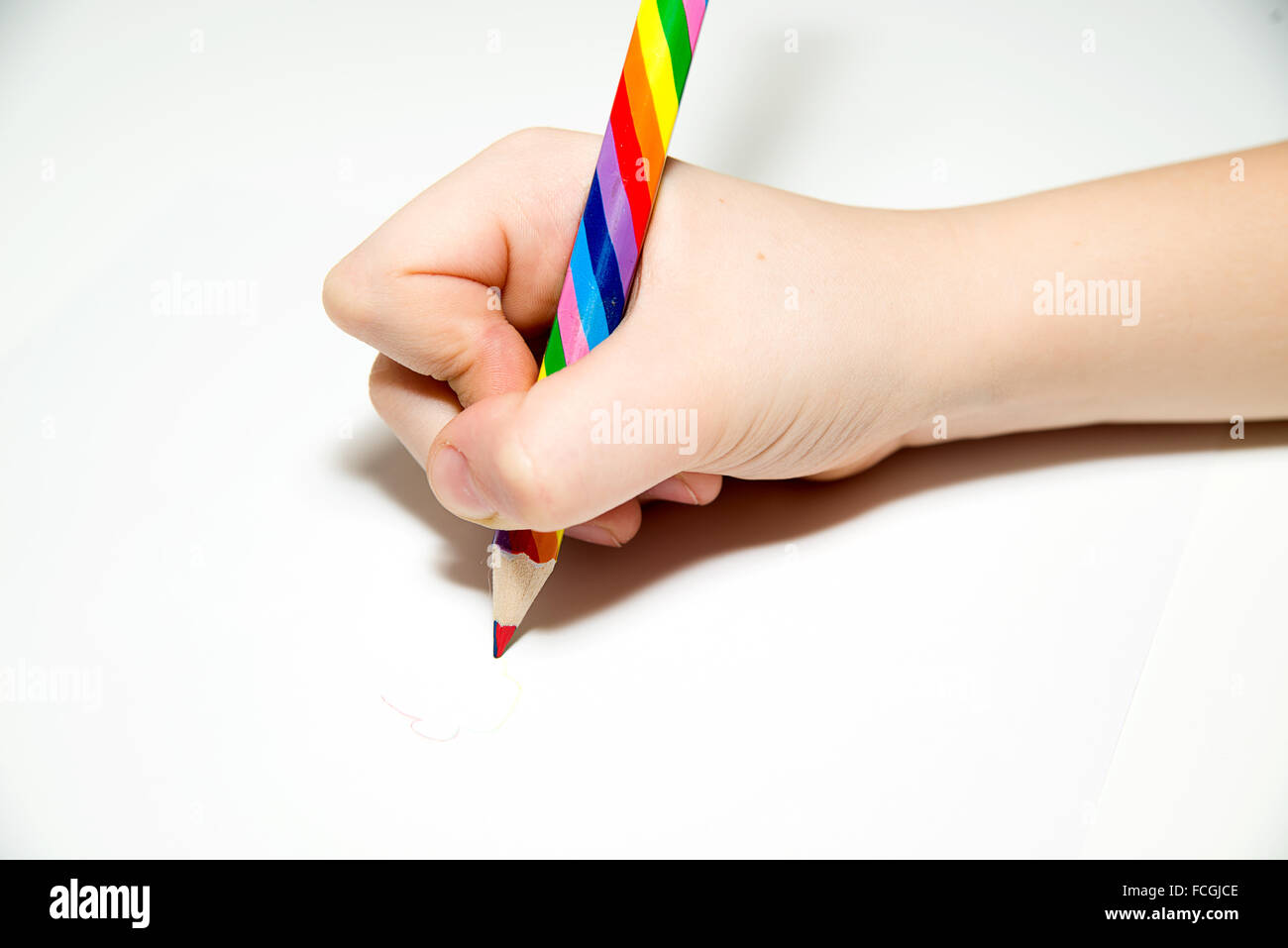 Kid's rigth hand holding a pencil on a white Stock Photo - Alamy