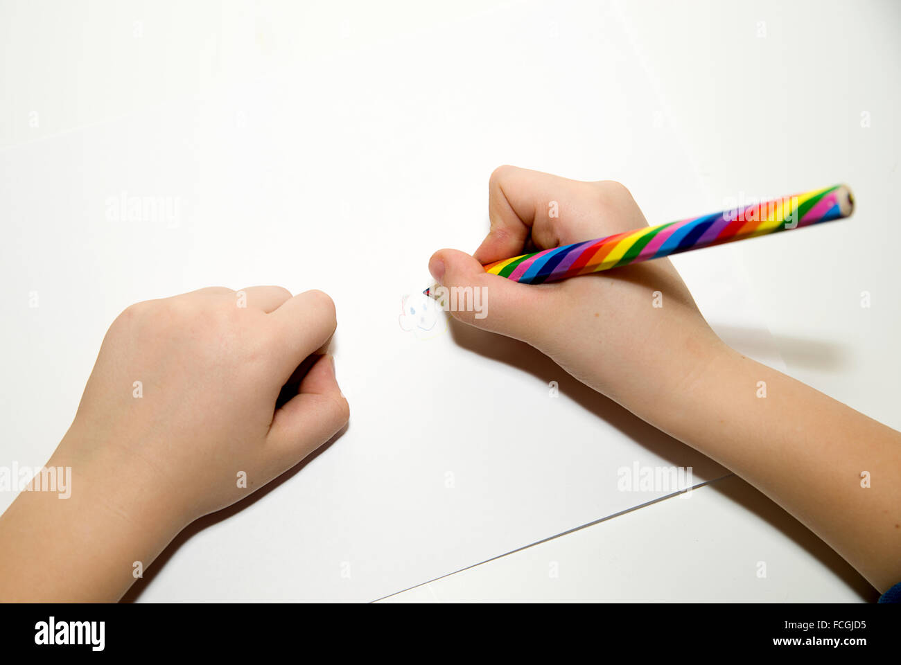 Kid's hands holding a pencil on a white Stock Photo - Alamy