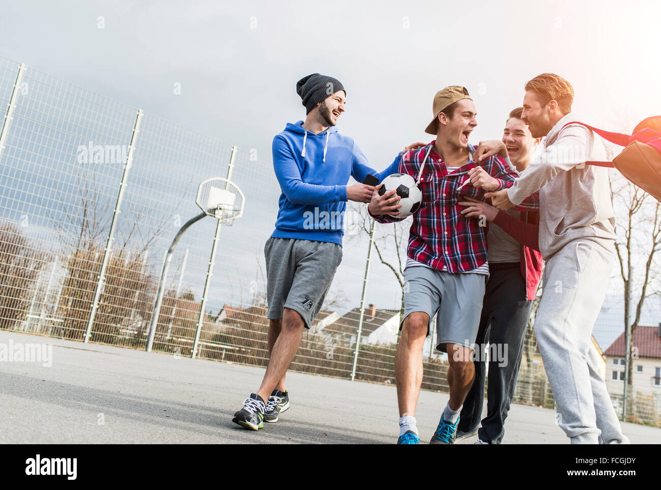 Four young football players Stock Photo - Alamy