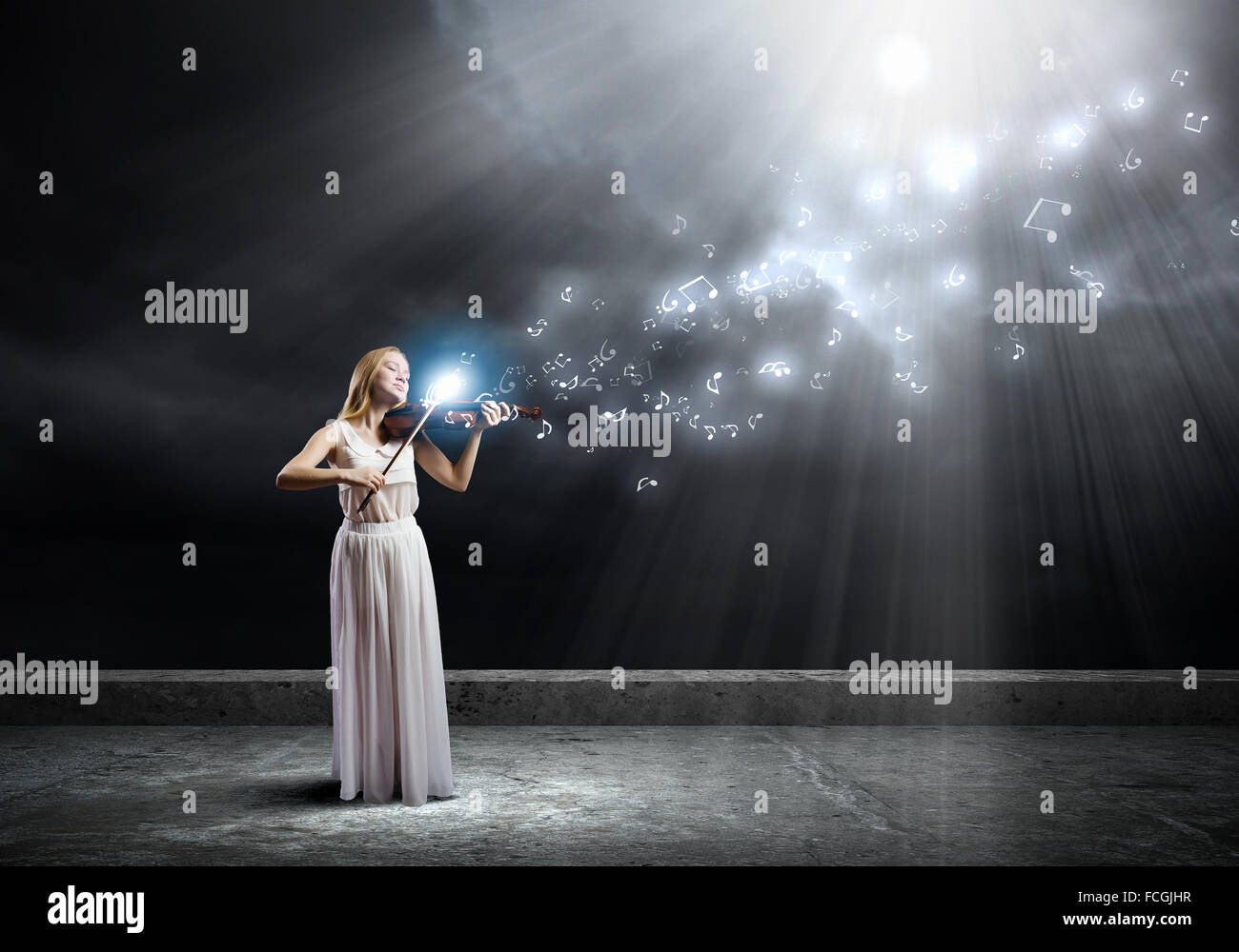 Young woman in white dress playing violin at night Stock Photo - Alamy