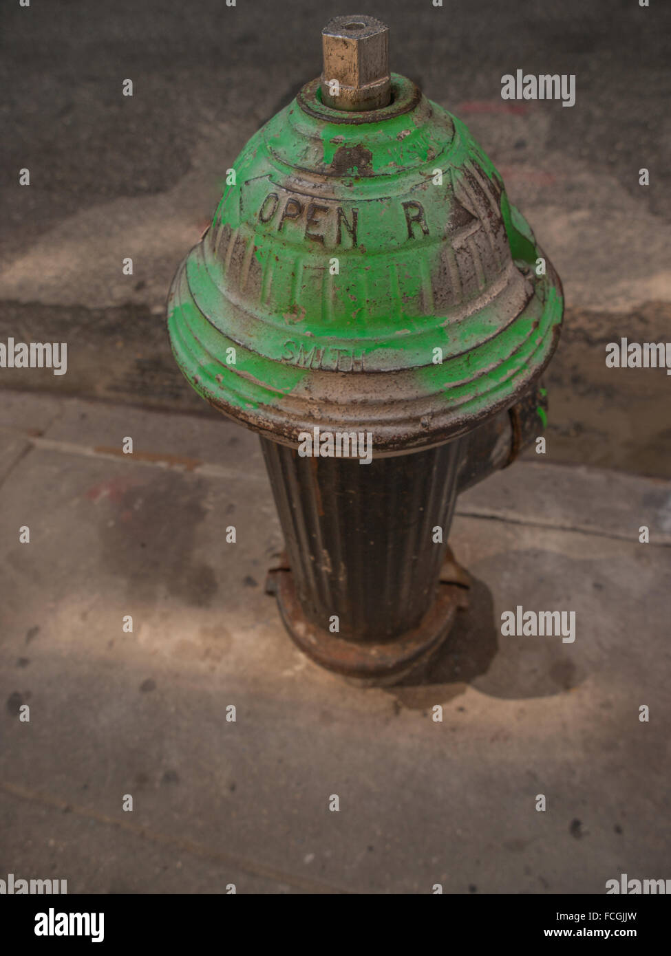 Green peeling fire hydrant on a sidewalk in Manhattan, New York City ...