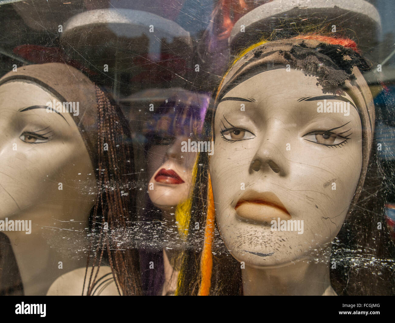 Three female caucasian mannequin heads wearing scarves with very ...