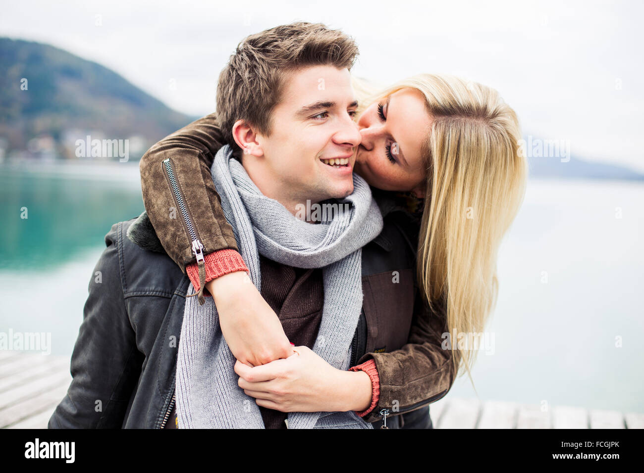 Young couple kissing on a lake Stock Photo - Alamy