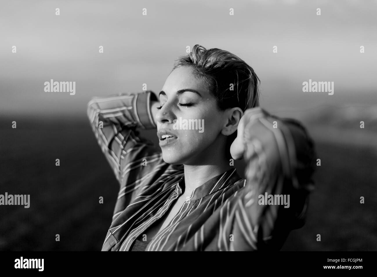 Portrait of relaxed woman closed eyes and hands behind her head Stock ...