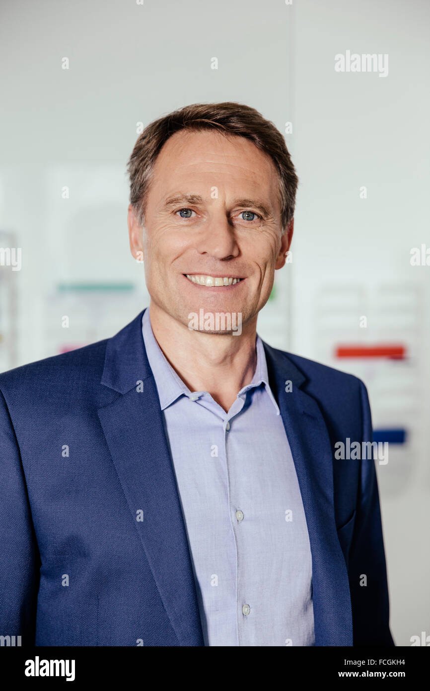 Male manager standing in office Stock Photo - Alamy