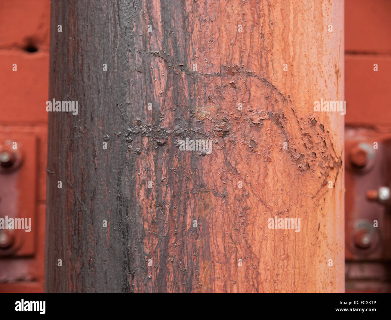 Rusted metal post against painted red brick wall in downtown Montreal ...