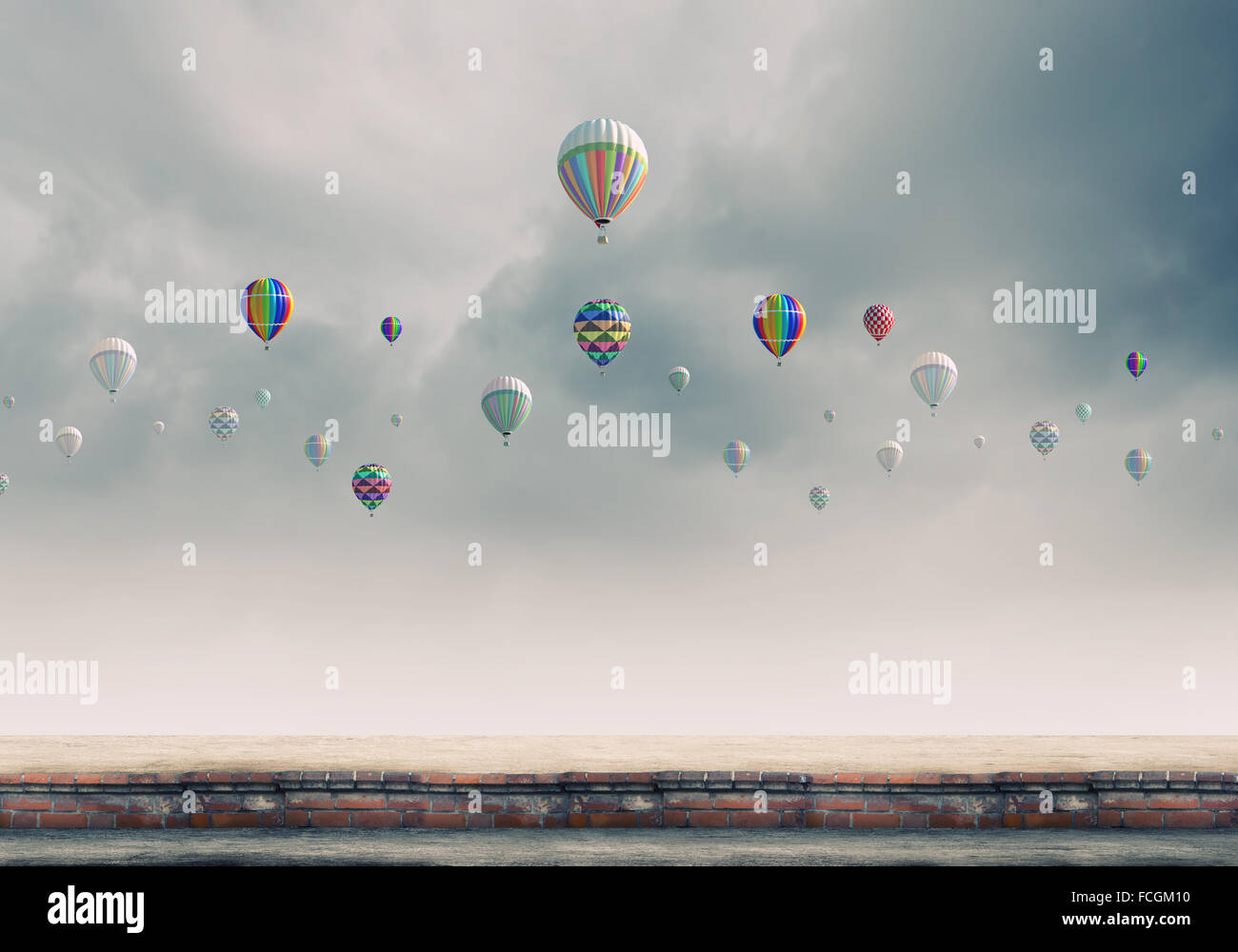 Colorful balloons flying high in grey sky Stock Photo - Alamy