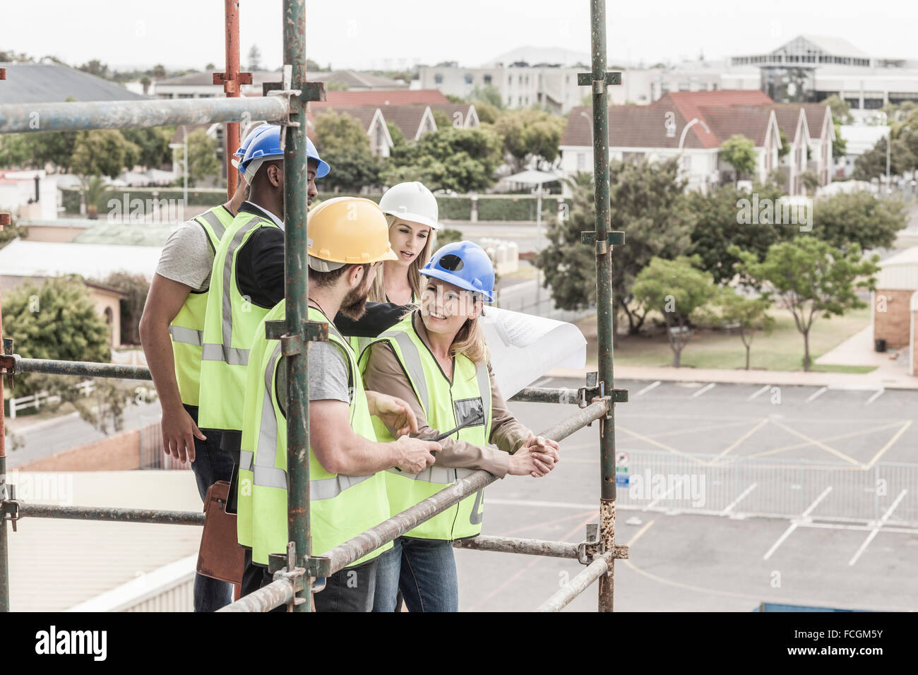 Construction workers and architects talking on scaffolding Stock Photo ...