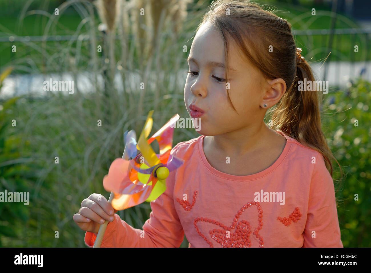 Portrait of little girl pinwheel Stock Photo - Alamy