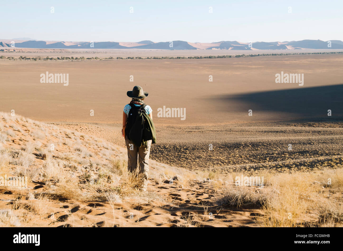 Namibia Namib Desert Sossusvlei Woman hat and backpack looking at the ...