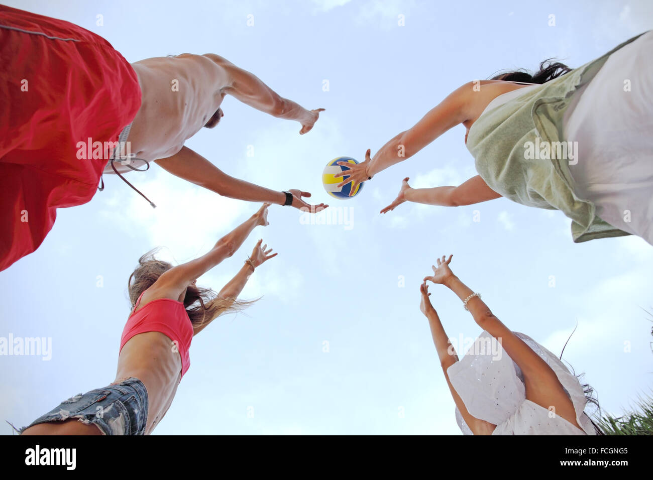 Group of young people playing volleyball outdoors Stock Photo - Alamy