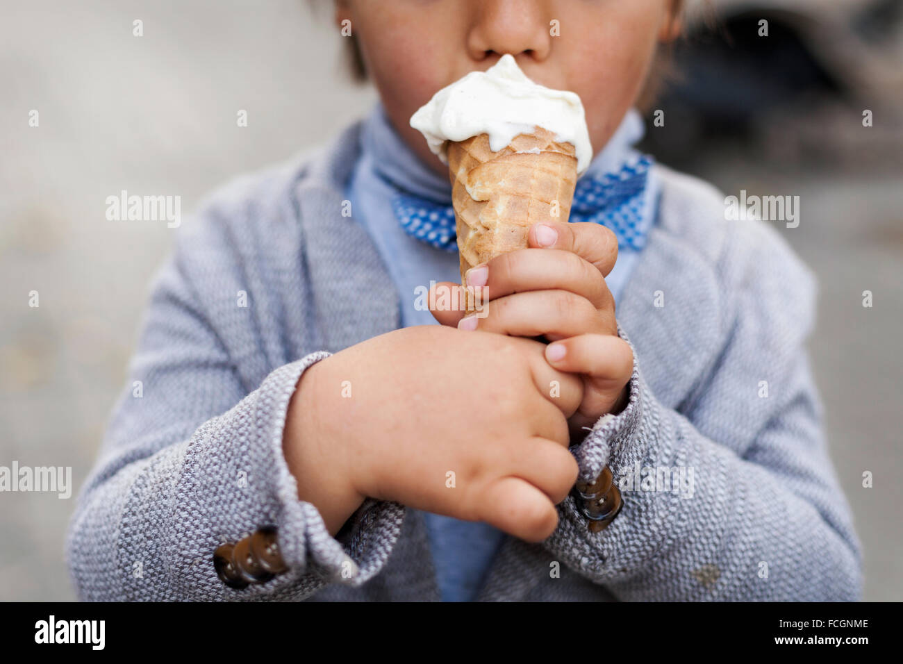 Little boy's hands holding ice cream cone Stock Photo - Alamy