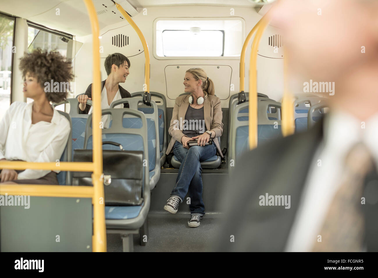 People talking in city bus Stock Photo - Alamy