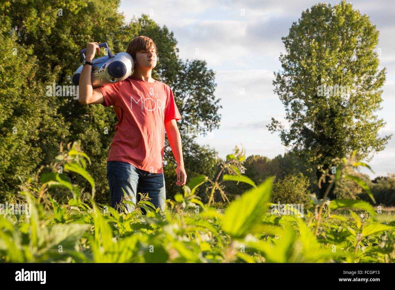 TEENAGER AND MUSIC IN NATURE Stock Photo - Alamy