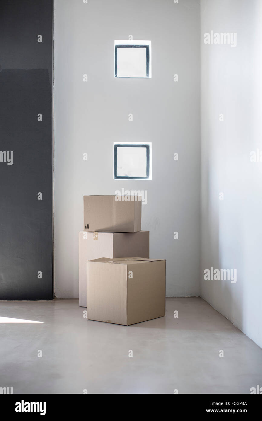 Cardboard boxes in a corner Stock Photo - Alamy