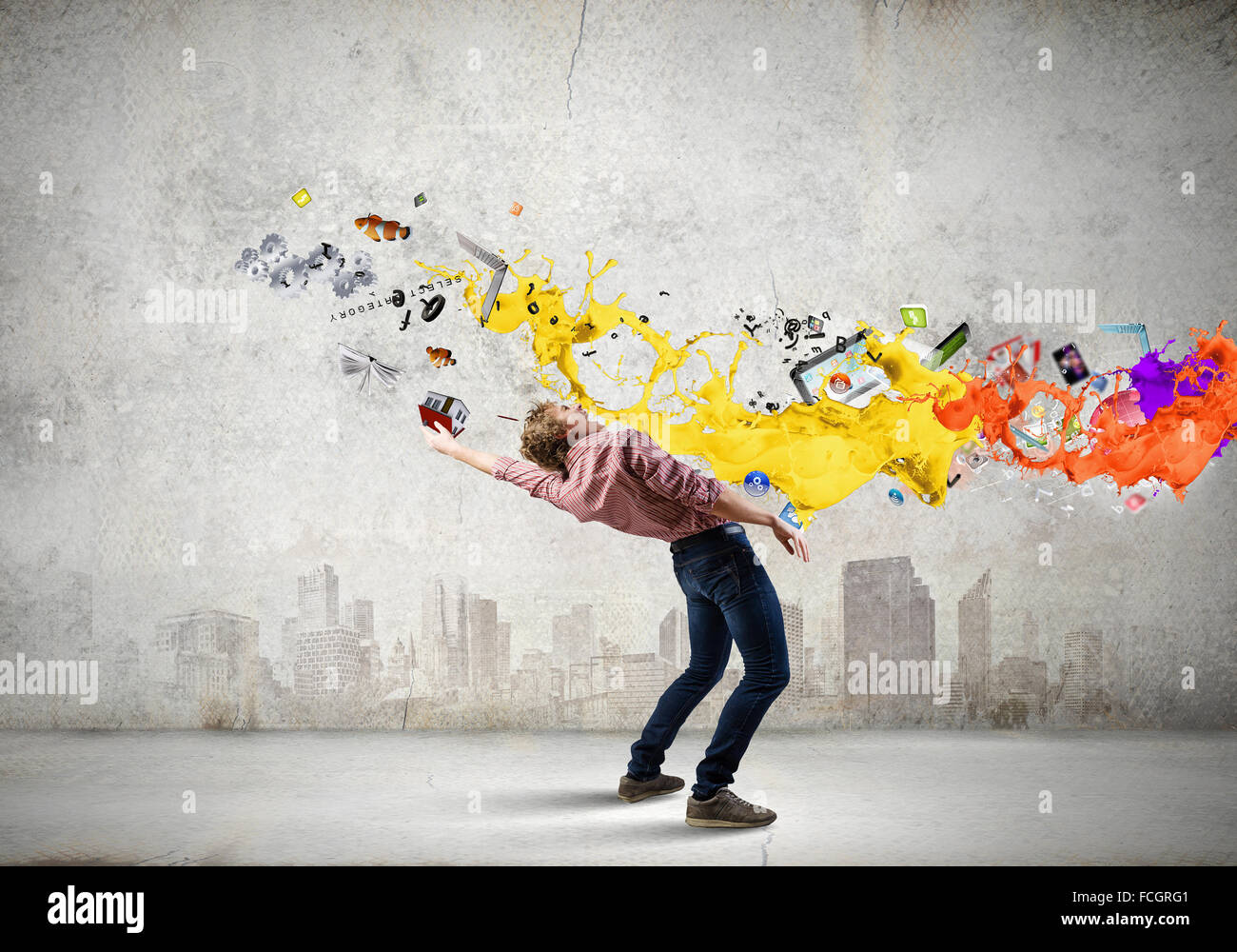 Young man in casual evading from flying icons Stock Photo - Alamy