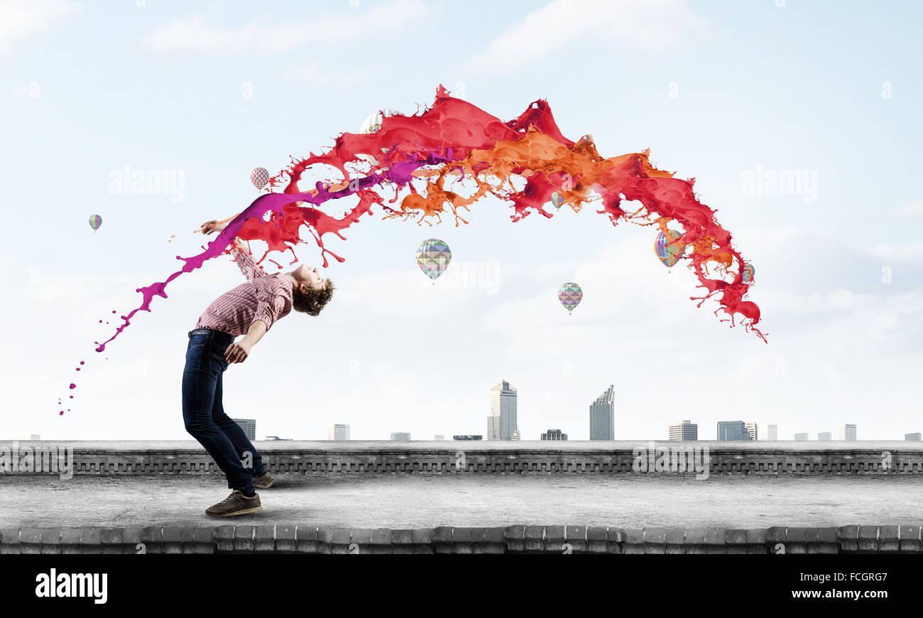 Young man in casual evading from flying icons Stock Photo - Alamy