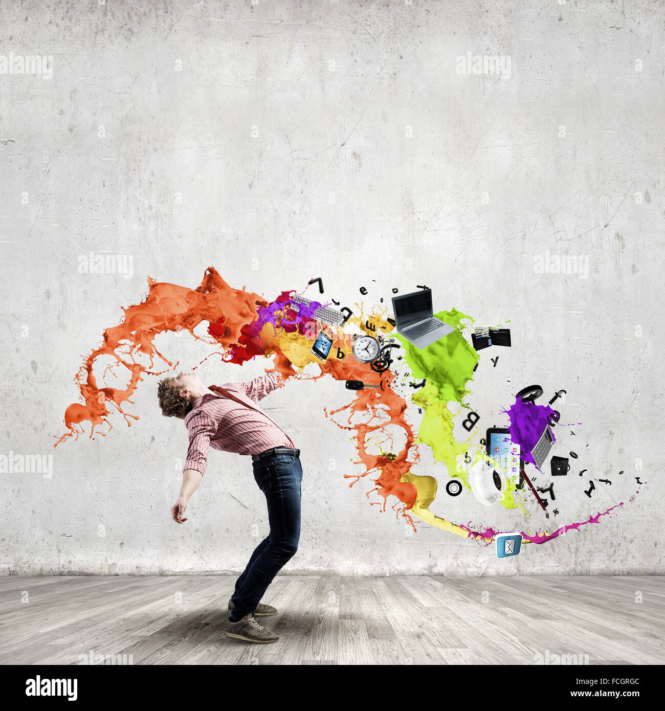 Young man in casual evading from flying icons Stock Photo - Alamy