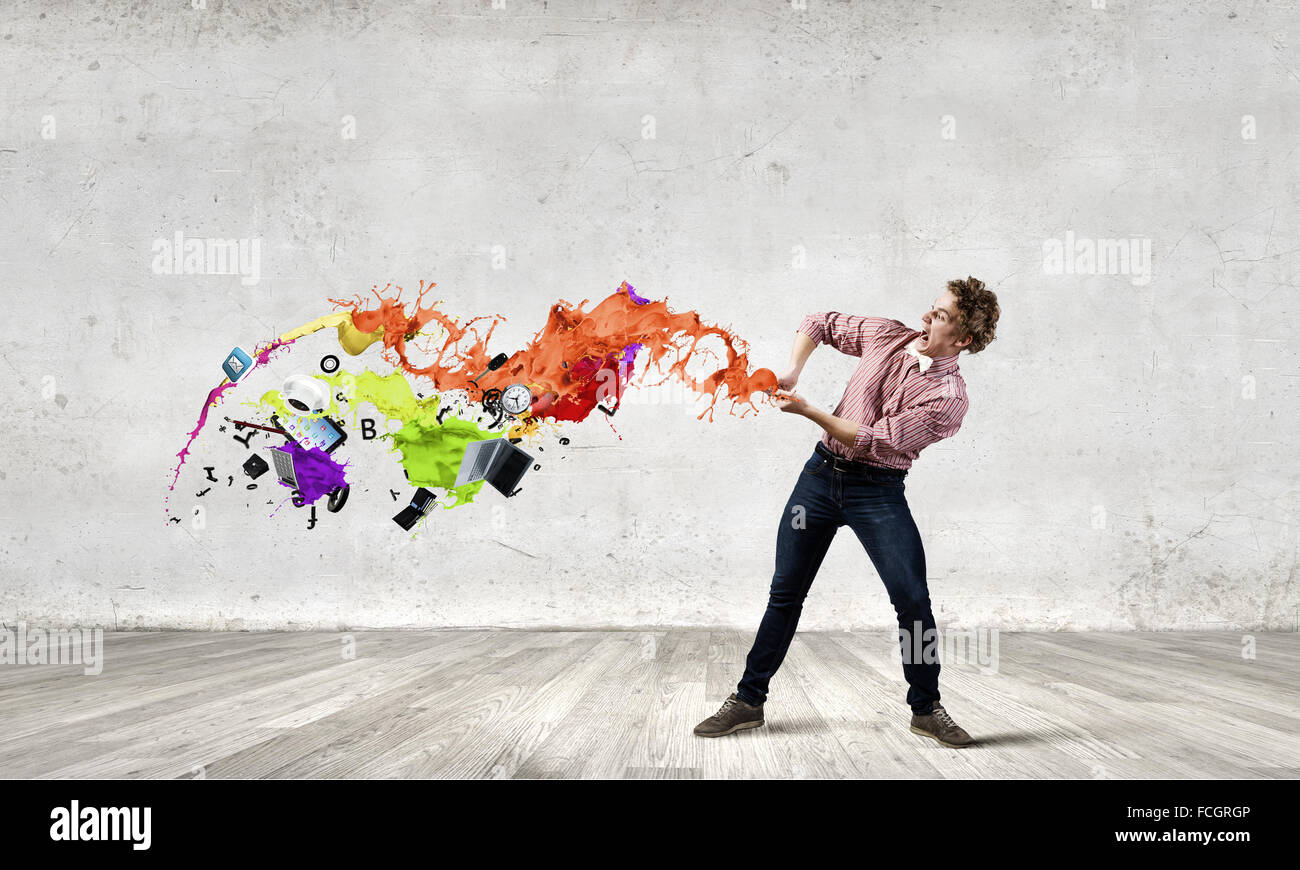 Young man in casual evading from flying icons Stock Photo - Alamy