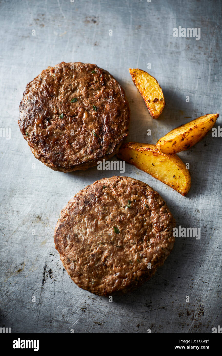 Fried ground beef, burger and potato wedges Stock Photo - Alamy